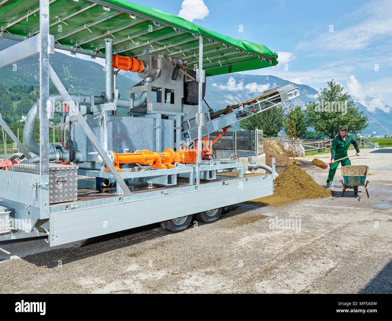 Farmer working with fertilizer on a farm Stock Photo - Alamy