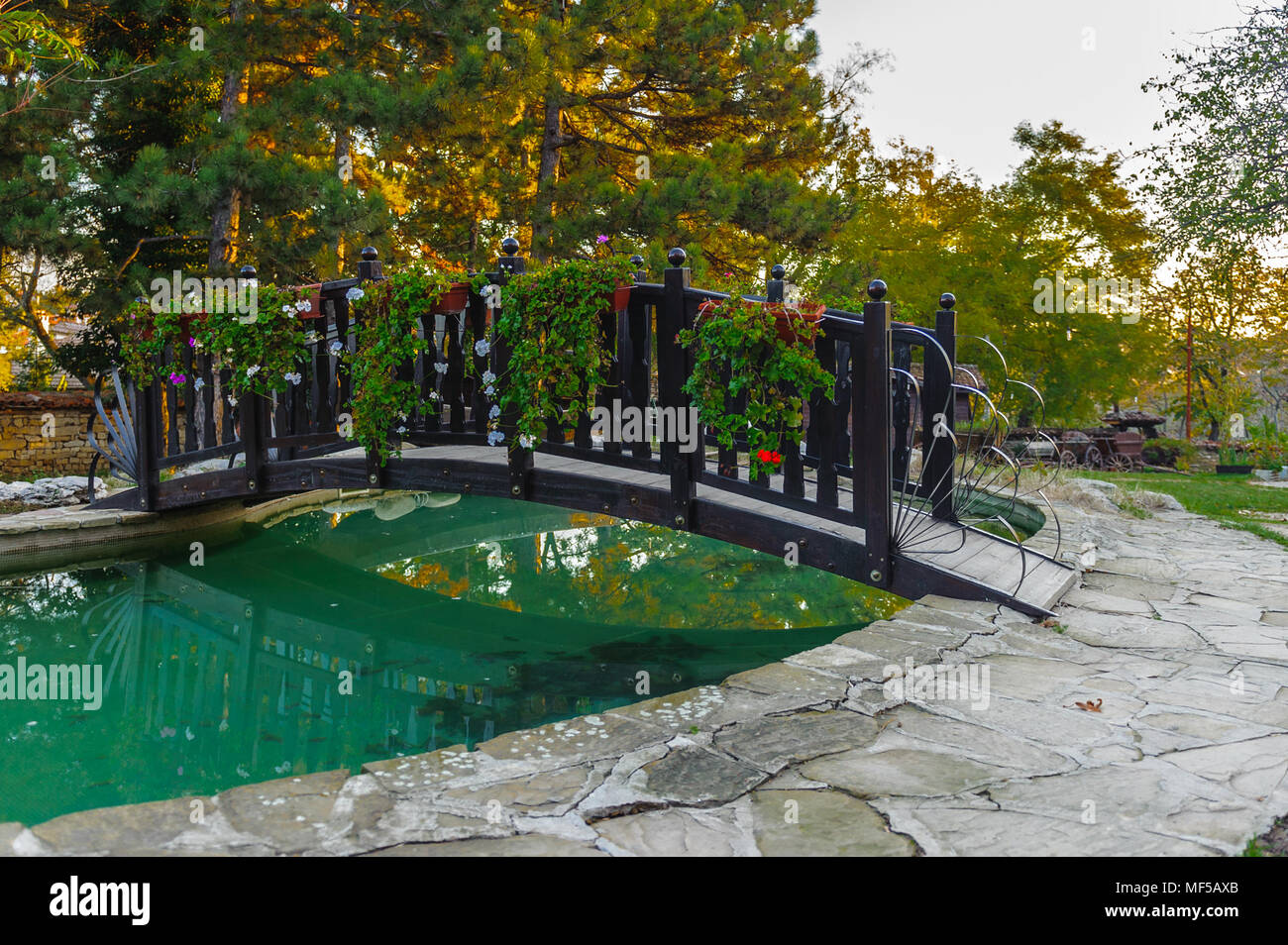 Decorative bridge over the creek Stock Photo - Alamy