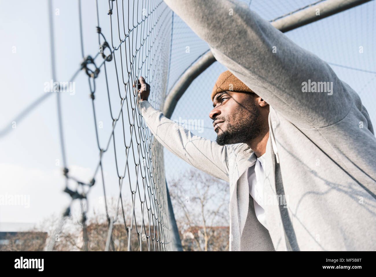 Man leaning against fence hi-res stock photography and images - Alamy