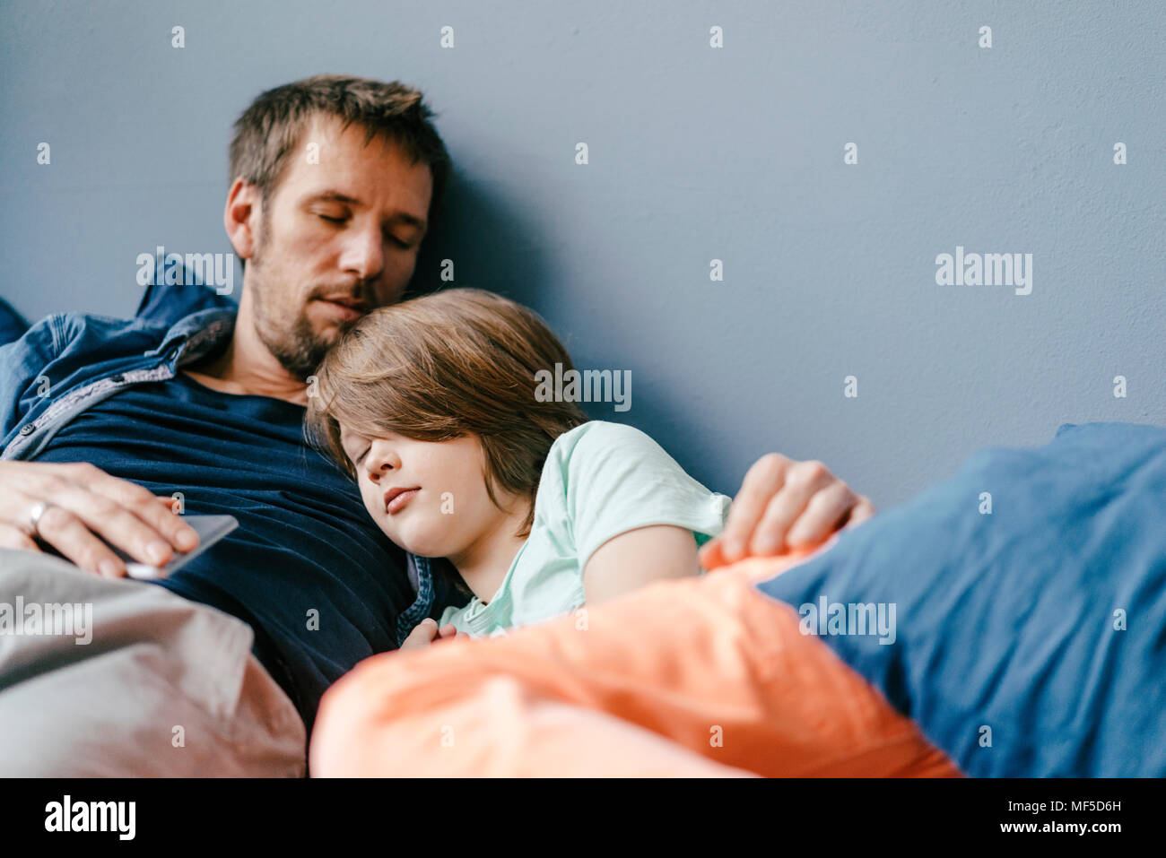 Father and son sleeping at home Stock Photo - Alamy