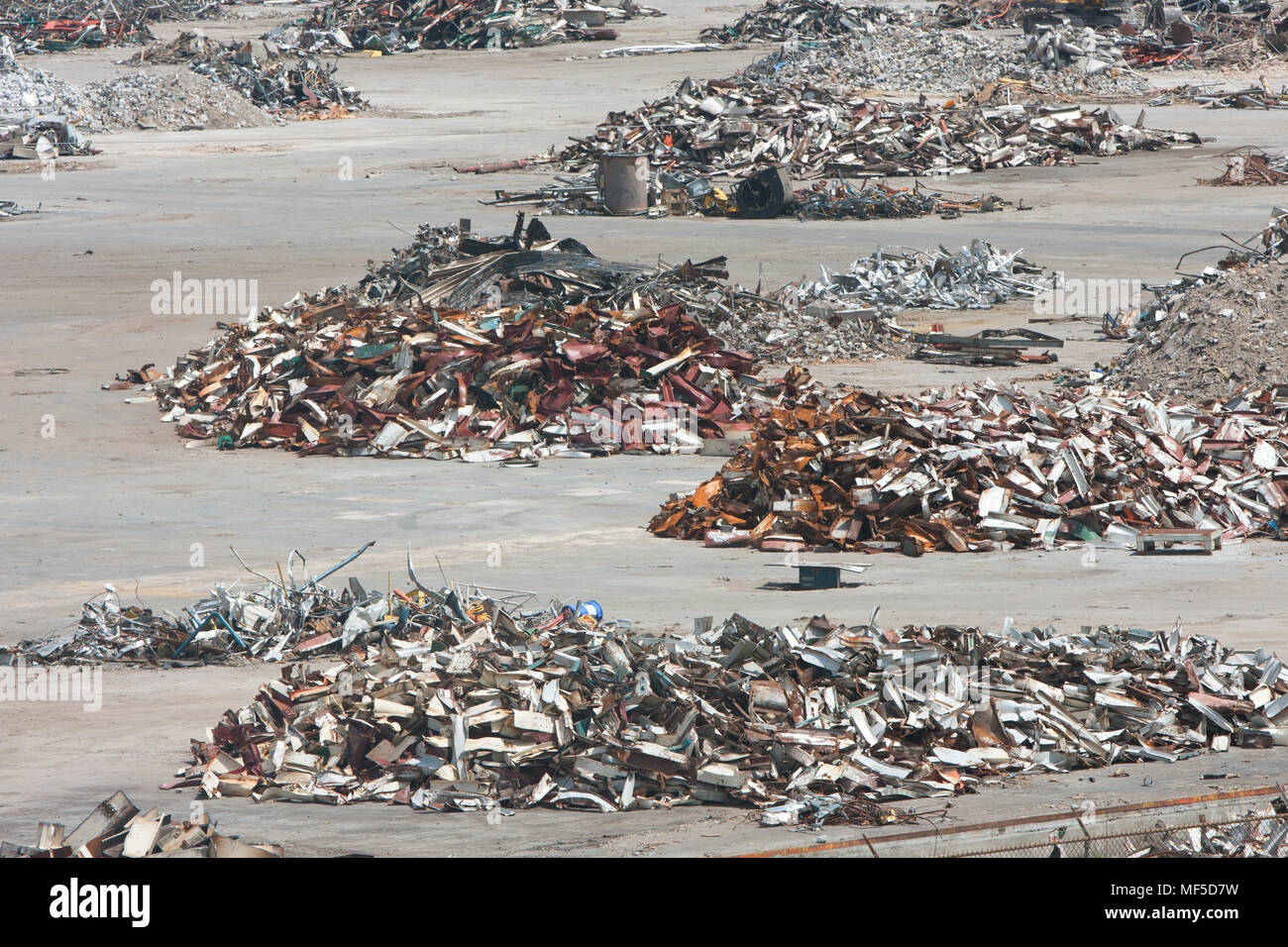 Piles of twisted metal, broken concrete and debris litter a demolition ...