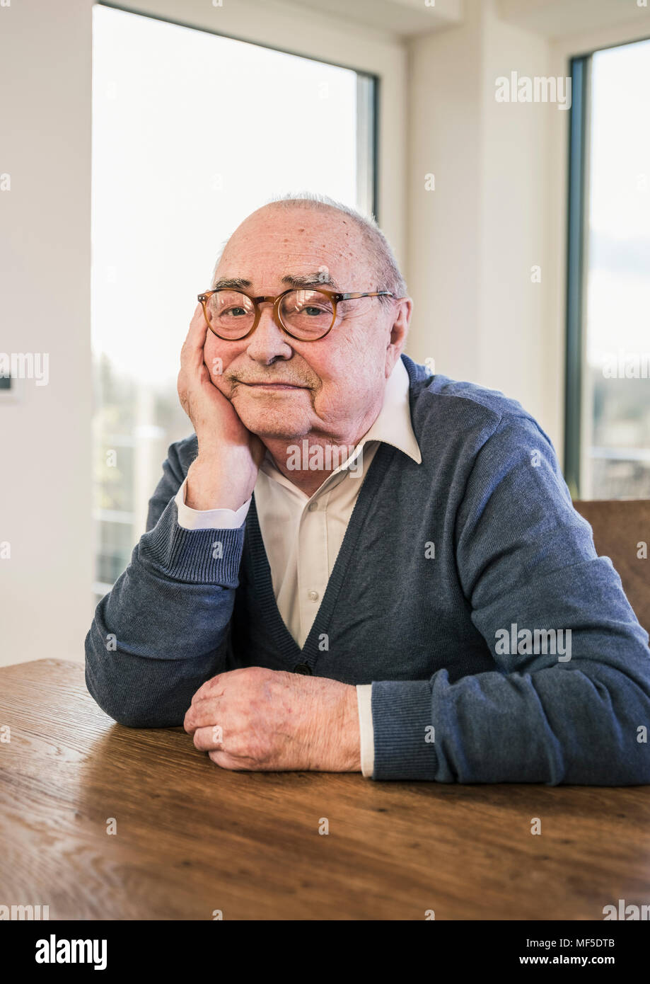 Old man sitting at table hi-res stock photography and images - Alamy