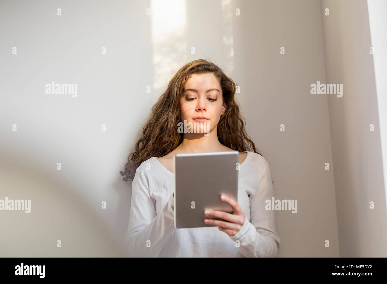 Teenage girl using digital tablet Stock Photo - Alamy