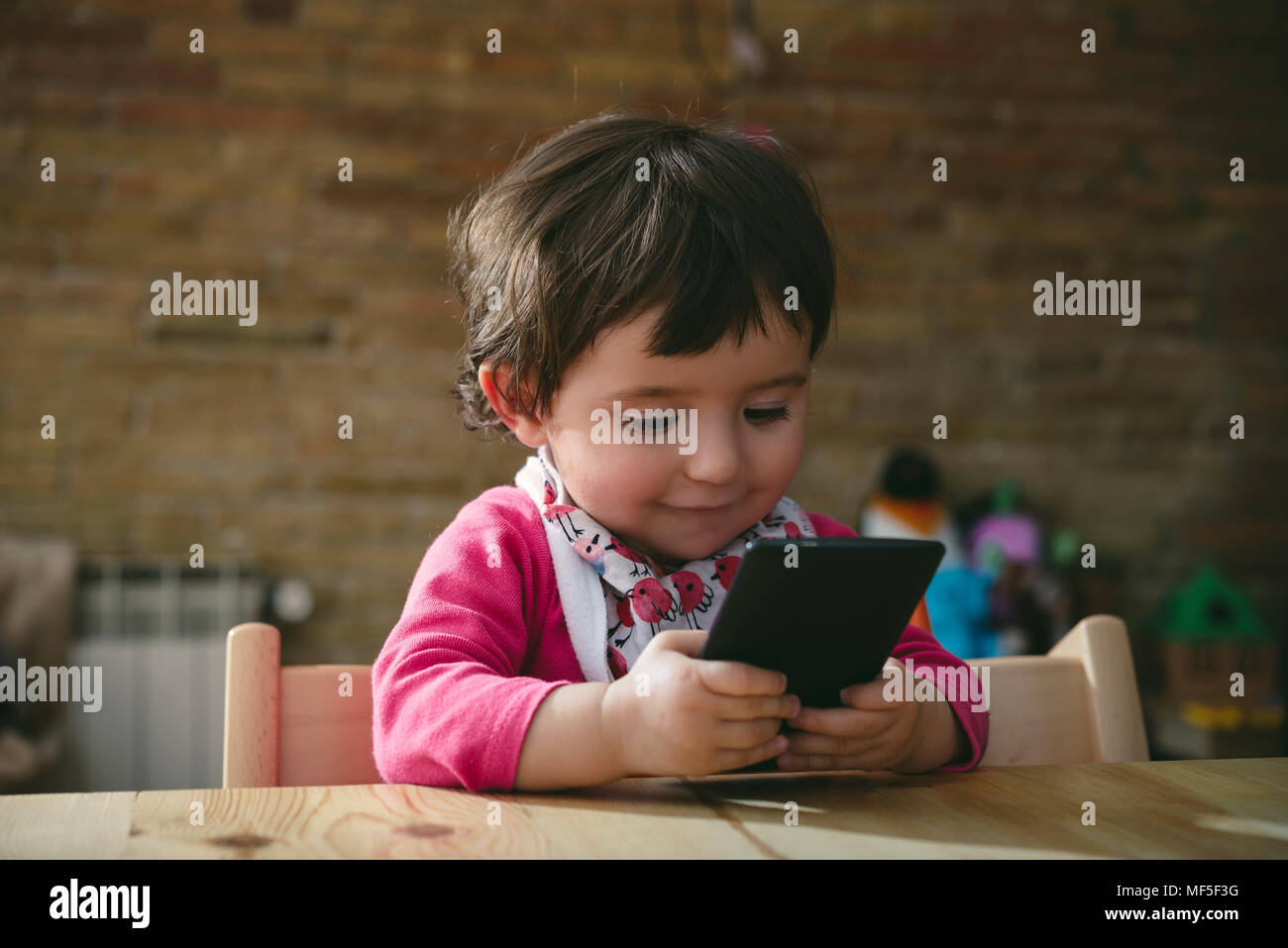 Baby using mobile phone hi-res stock photography and images - Alamy