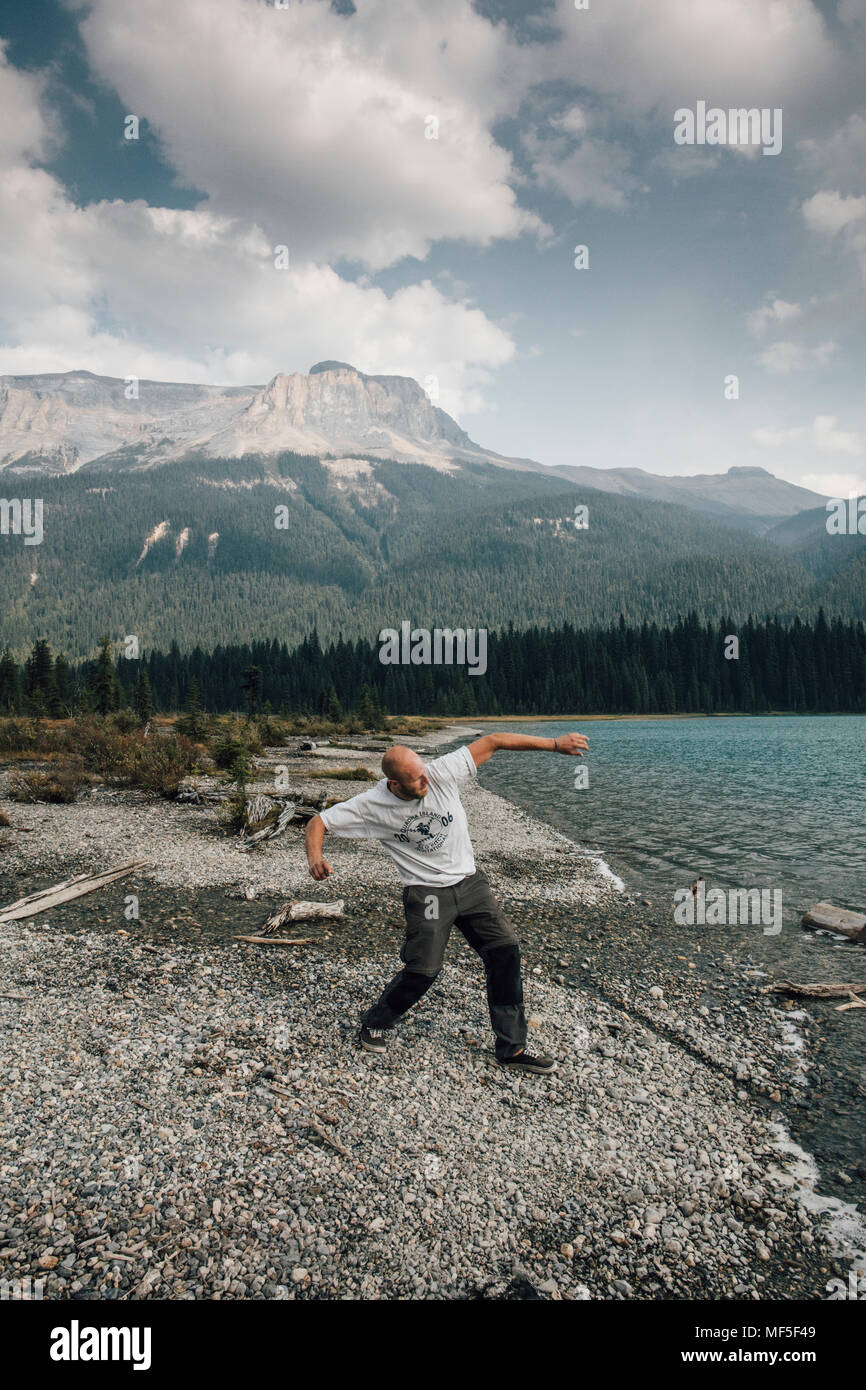 Man skipping stones at emerald lake hi-res stock photography and images ...