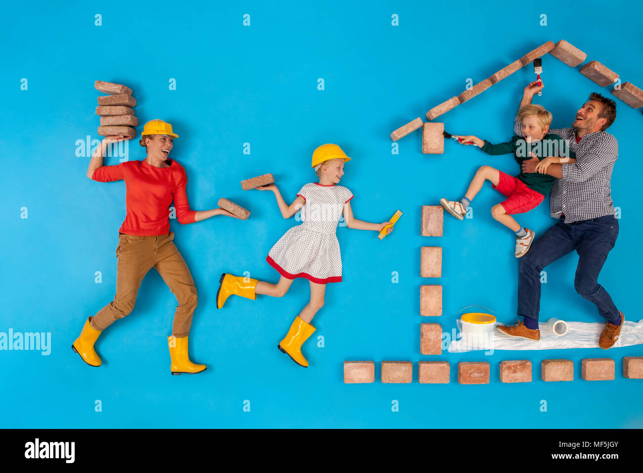 Family building and painting their new home Stock Photo - Alamy