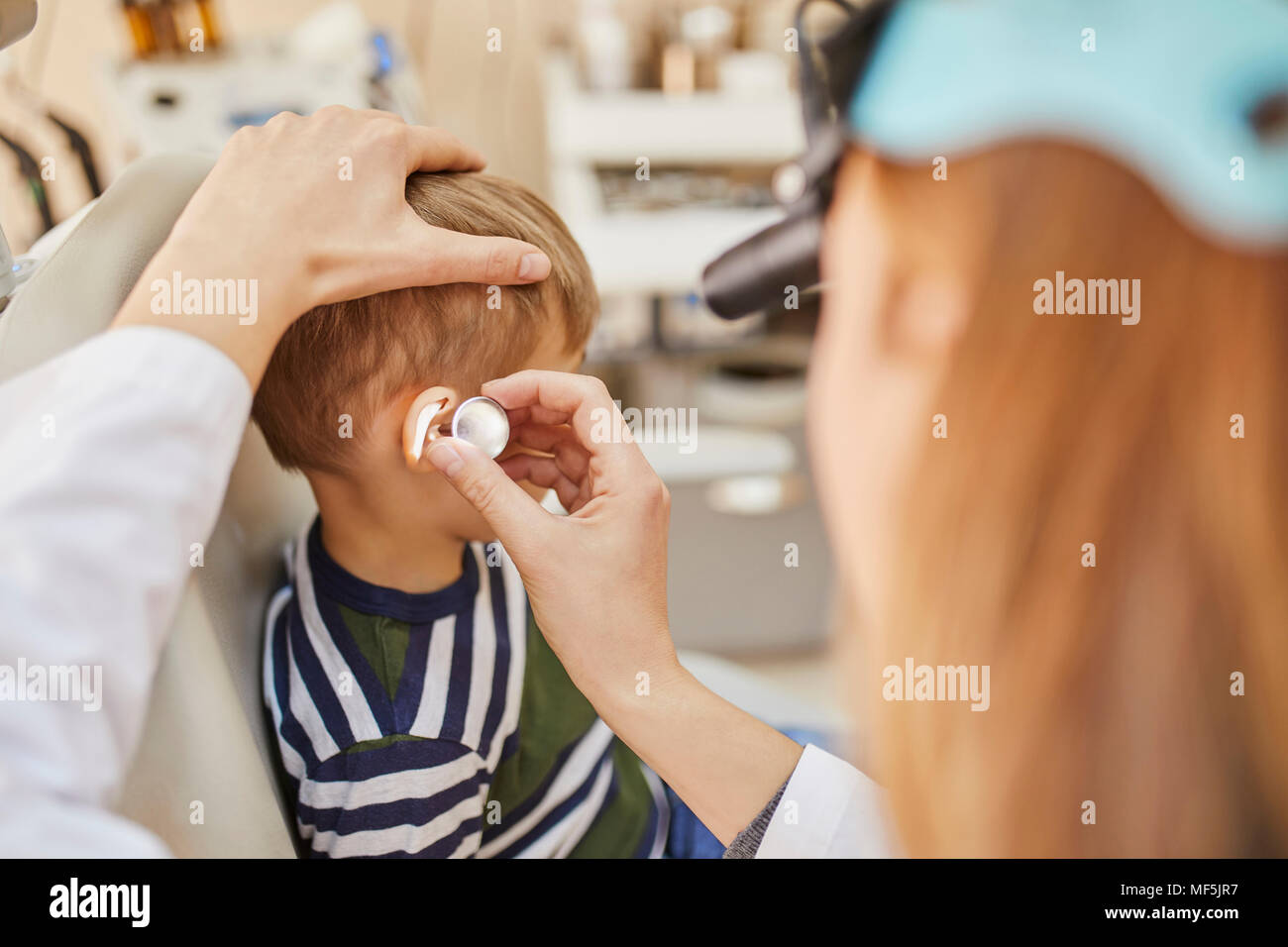 Boy doctor checking ear close hi-res stock photography and images - Alamy