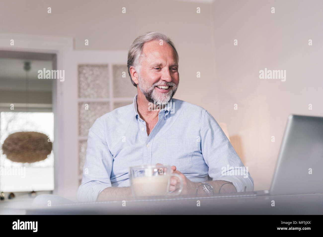 Happy man looking laptop hi-res stock photography and images - Alamy