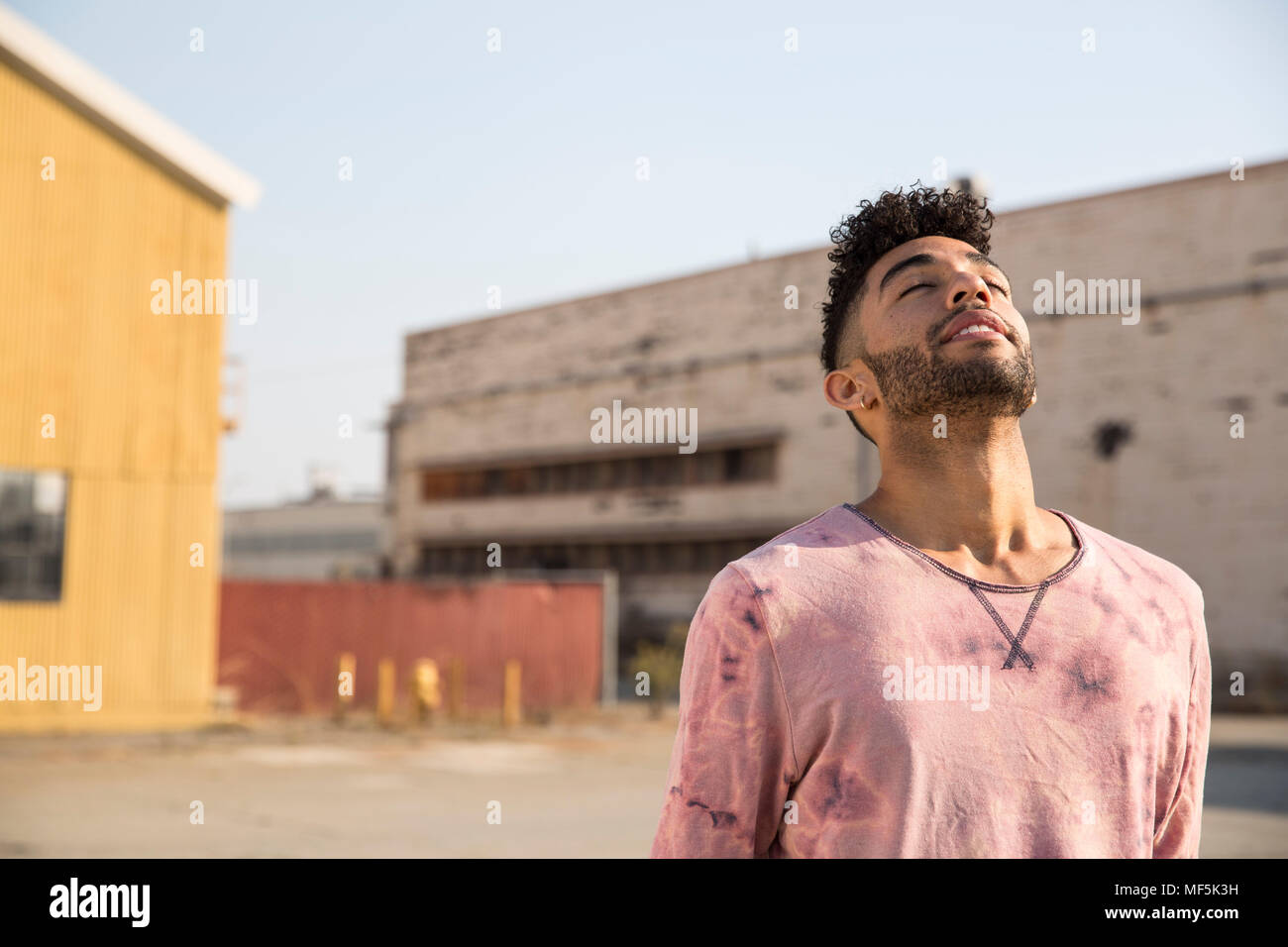 Young man outdoors leaning back Stock Photo - Alamy