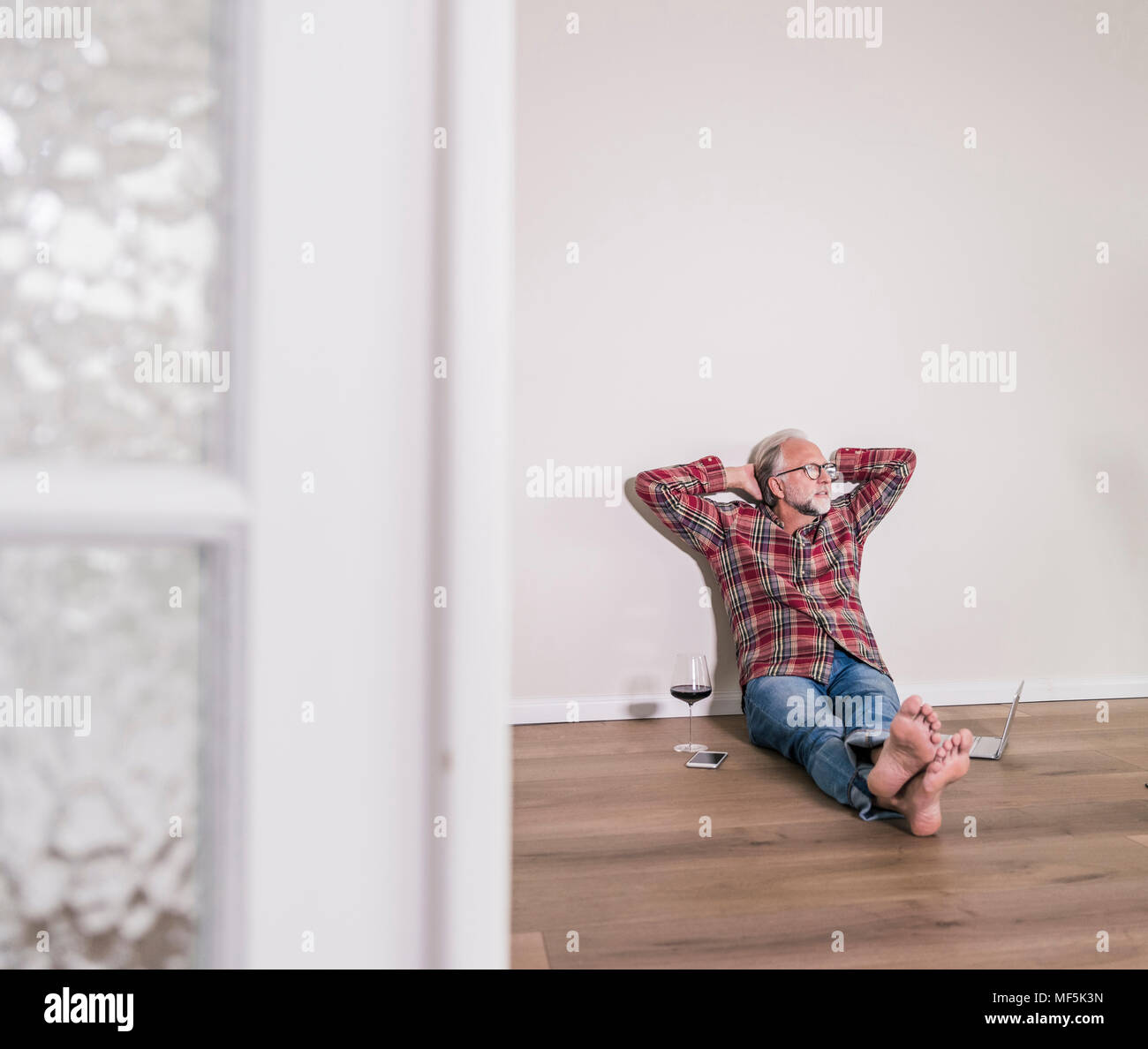 Barefoot man relaxing on the floor at home Stock Photo - Alamy