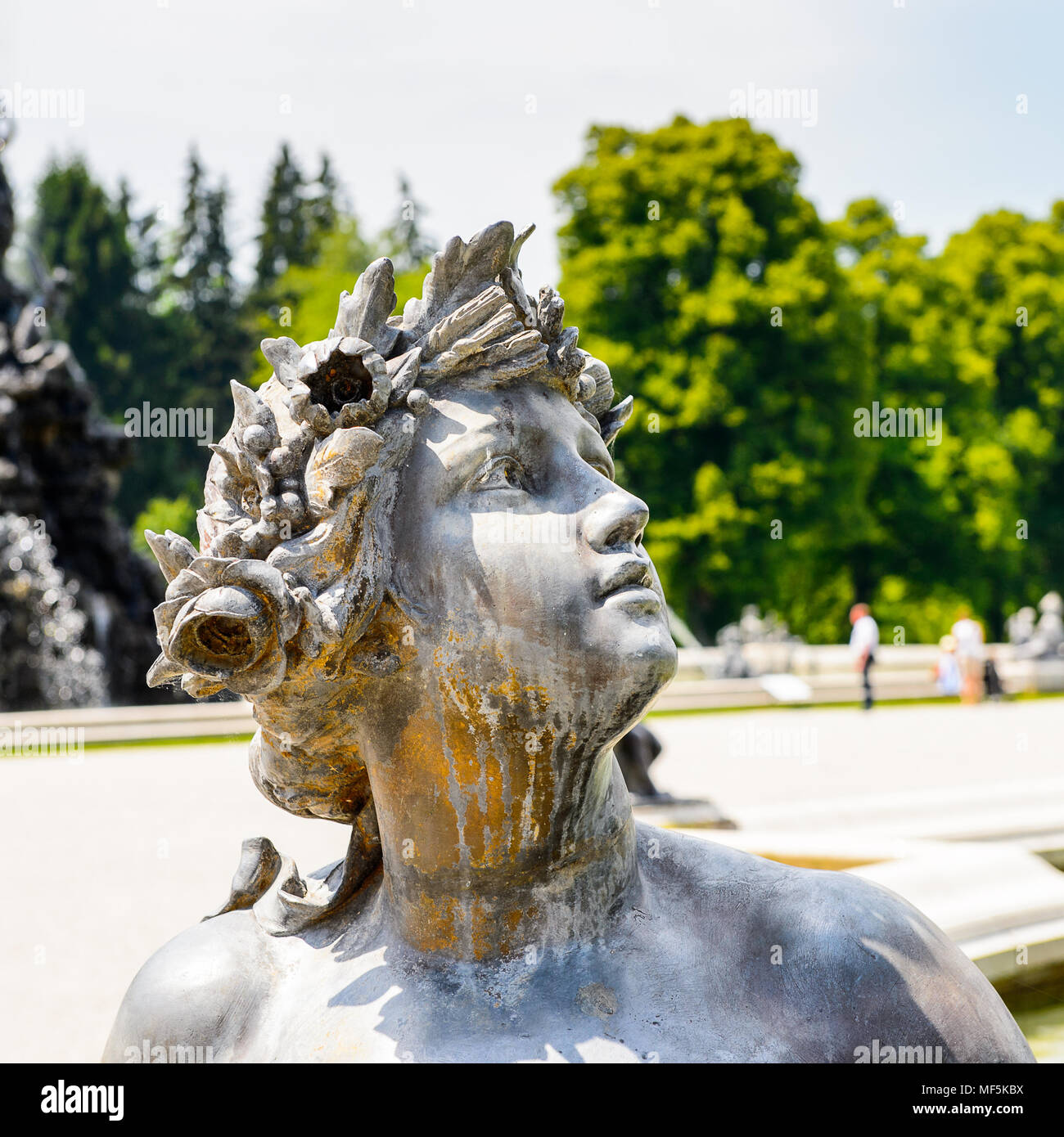 Statue of the fountain in front of the Herrenchiemsee Palace , one of ...