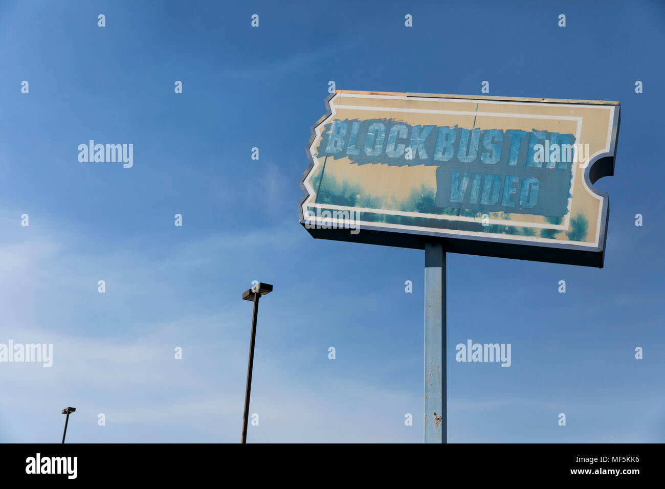 A painted over logo sign outside of a former Blockbuster Video retail ...