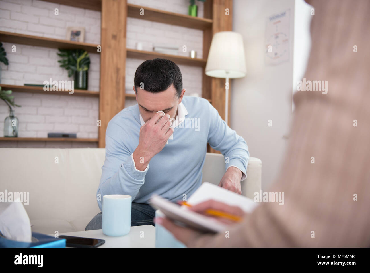 Upset sorrowful man demonstrating his mournfulness Stock Photo - Alamy