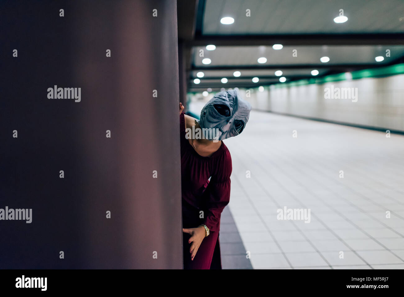 young woman indoor wearing alien mask - strange, carnival, halloween ...