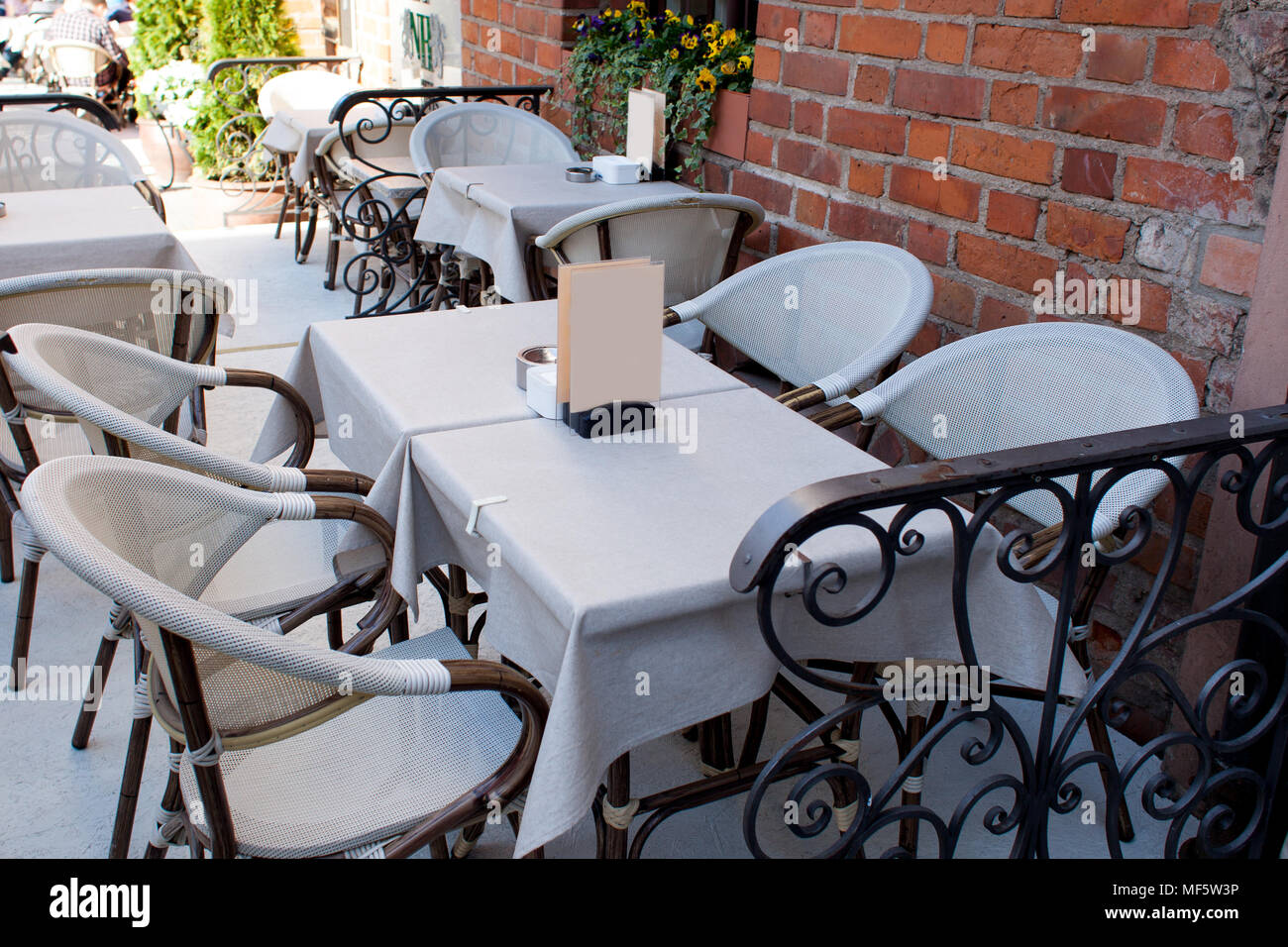 White design of tables and chairs of a cafe on a pedestrian street in ...