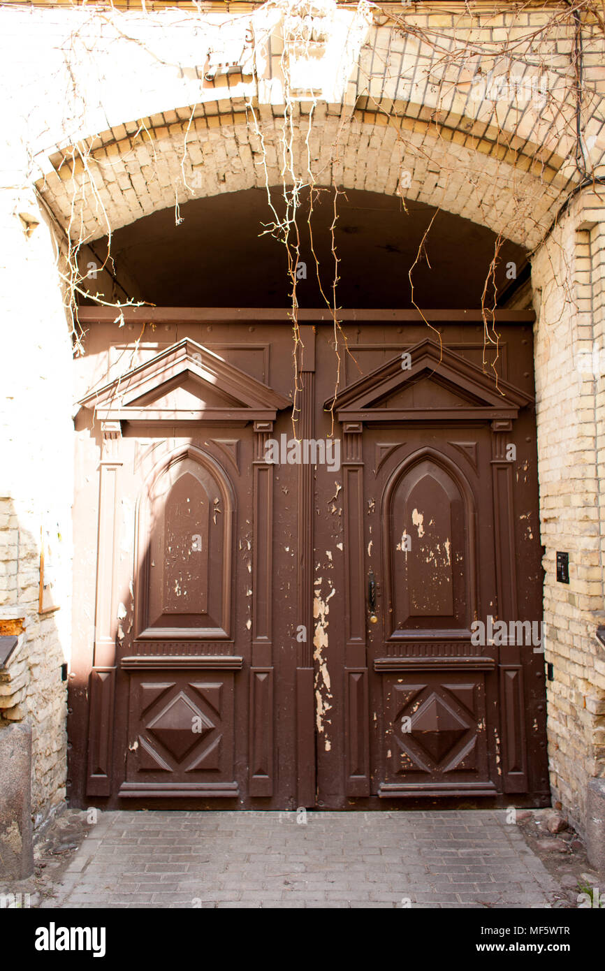 Old red doors with ripped paint with an arch at the top Stock Photo - Alamy