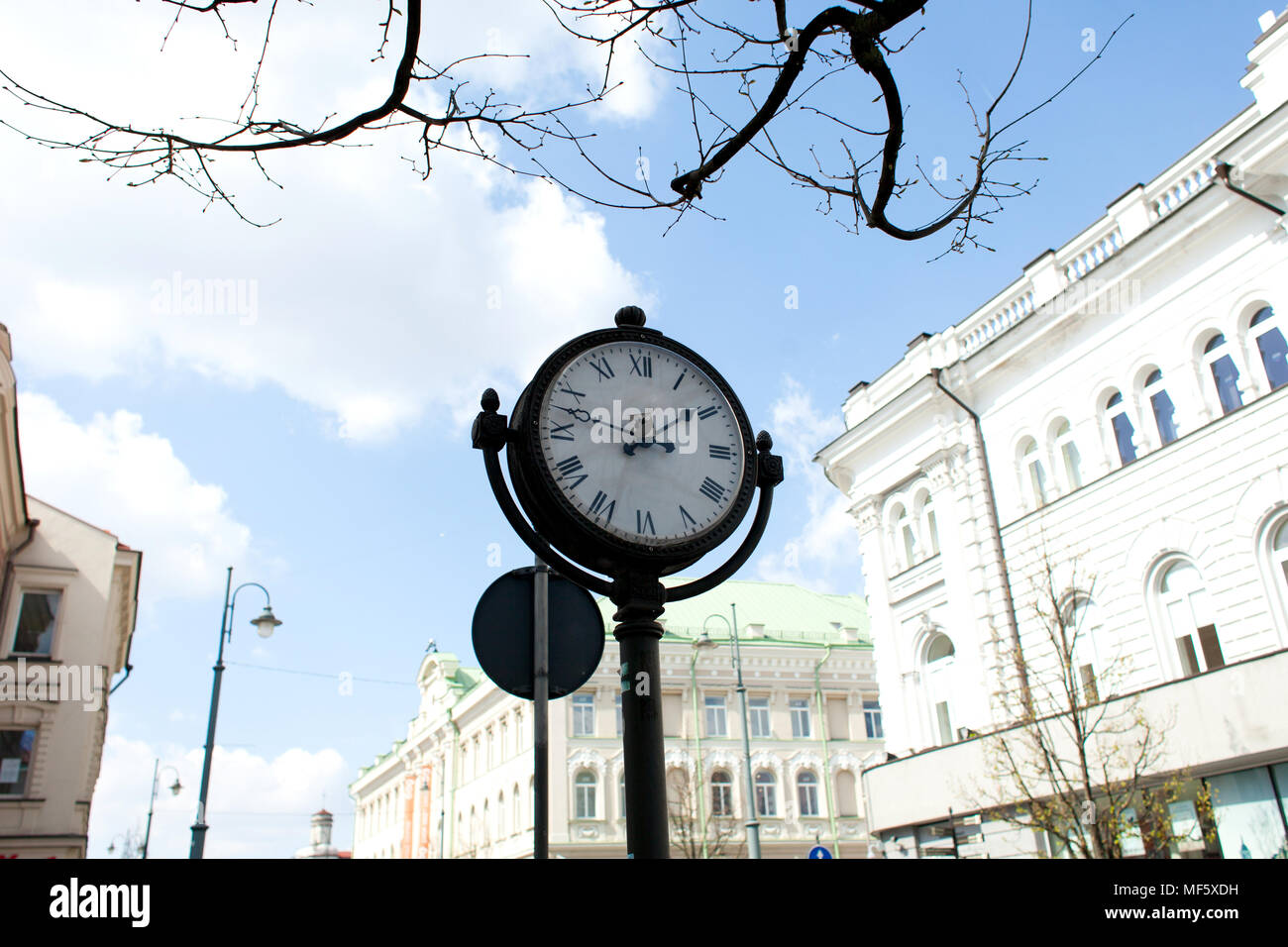 Retro clock on a street post in a European city in the spring Stock ...