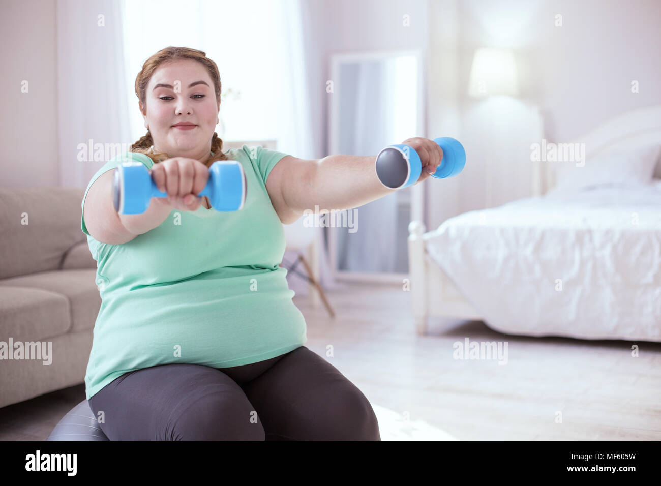 Concentrated young woman following instructions Stock Photo - Alamy