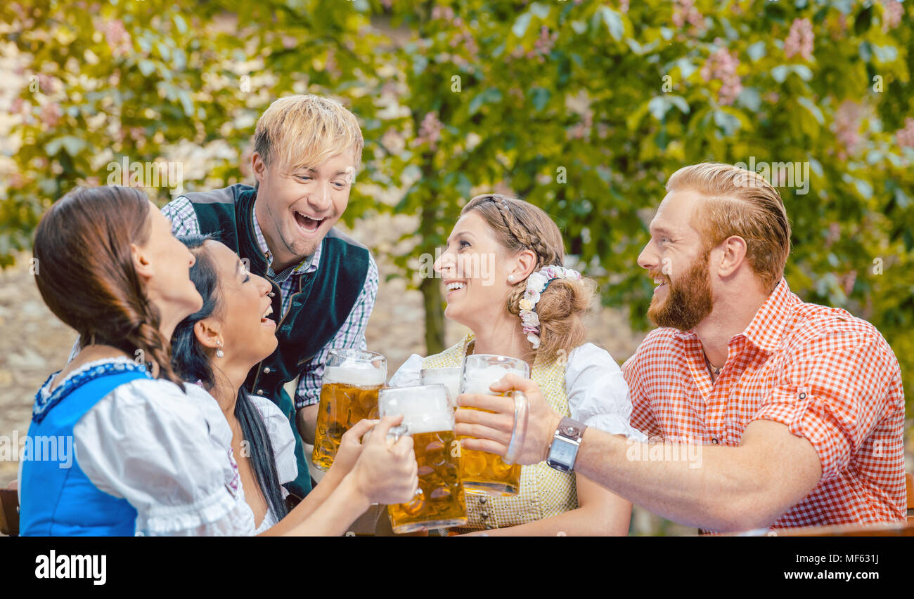 Friends drinking beer in beer garden Stock Photo - Alamy