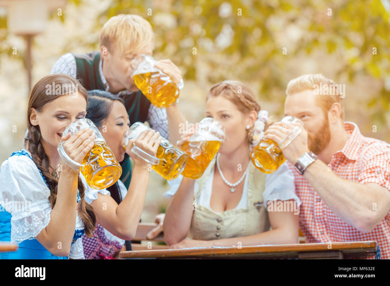 Friends drinking beer in beer garden Stock Photo - Alamy