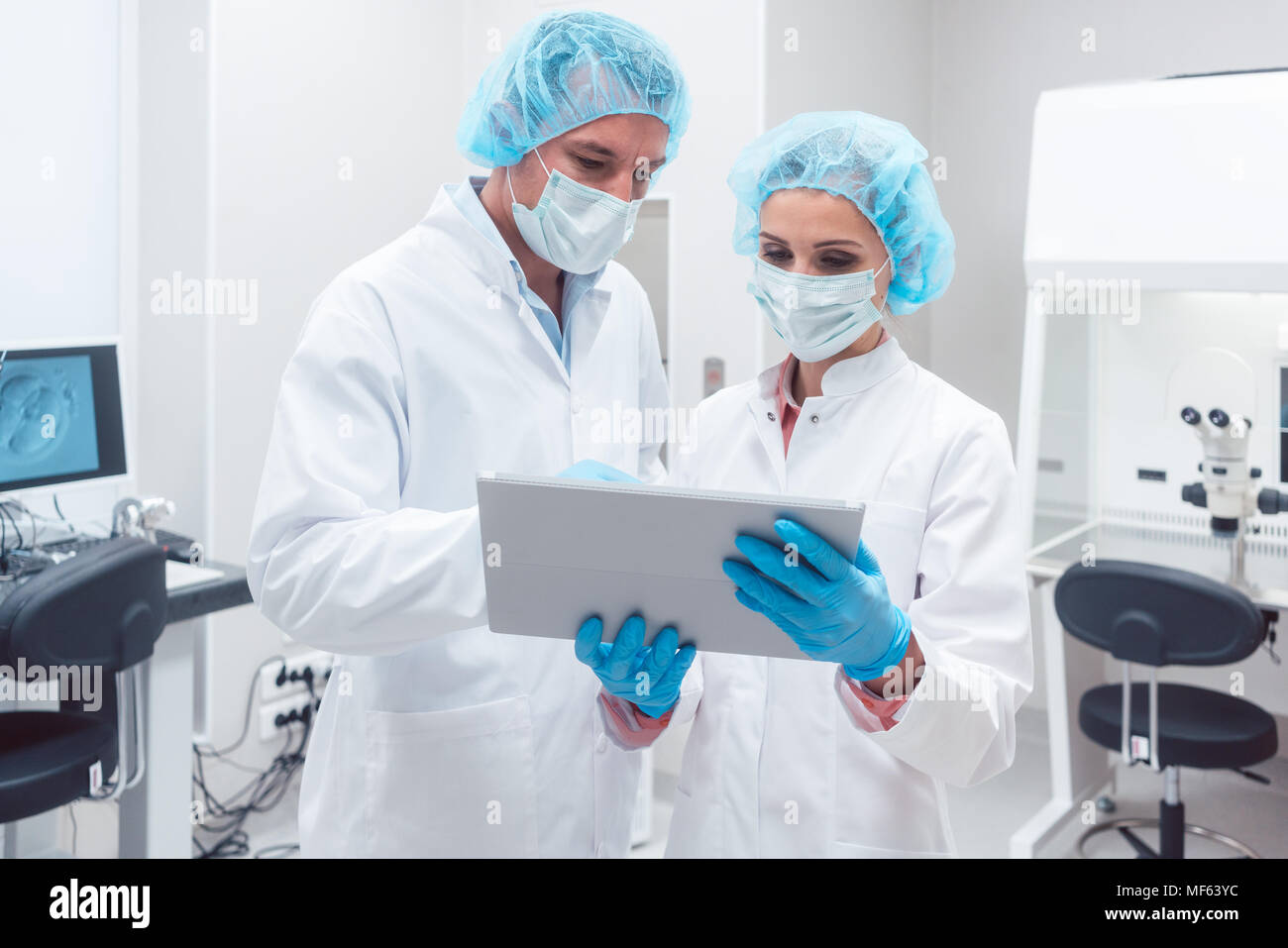 Two scientists working together in lab looking at data Stock Photo - Alamy