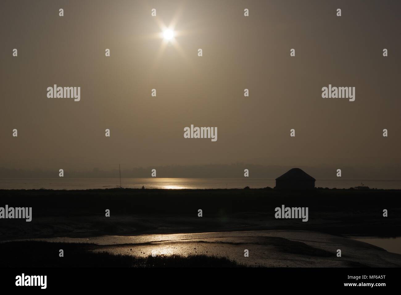 Silhouetted Yurt by a Misty Exe Estuary with a Starburst Sun. Turf Lock ...