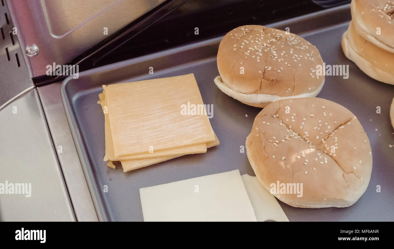 Step by step. Burger buns on the tray next to outdoor gas grill Stock ...