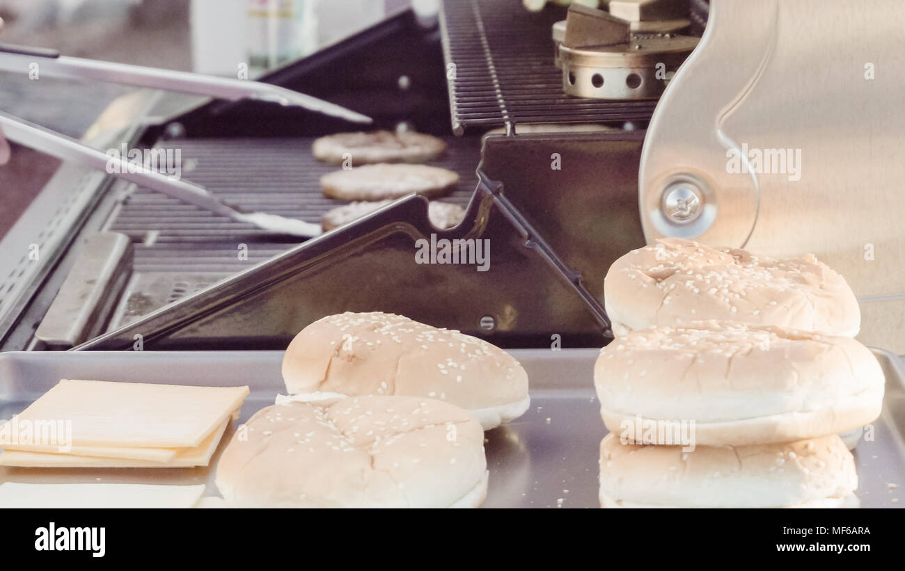 Step by step. Burger buns on the tray next to outdoor gas grill Stock ...