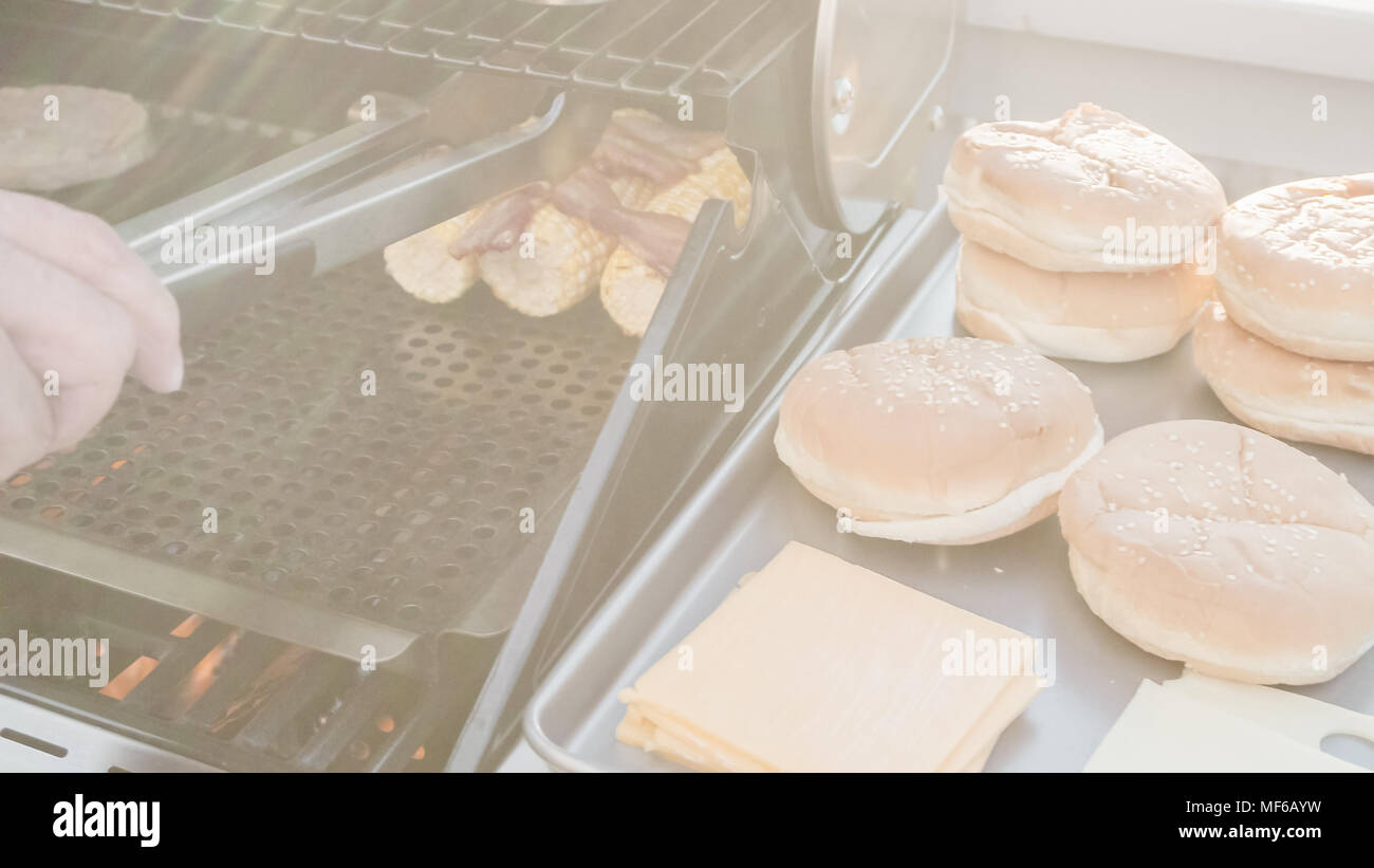 Step by step. Burger buns on the tray next to outdoor gas grill Stock ...