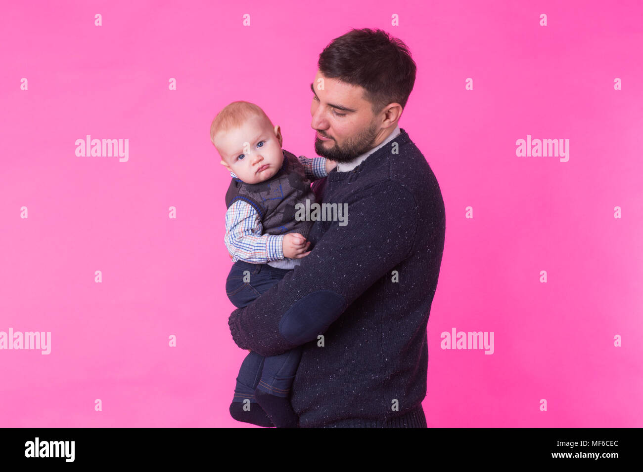 happy father with a baby son isolated on a pink background Stock Photo ...