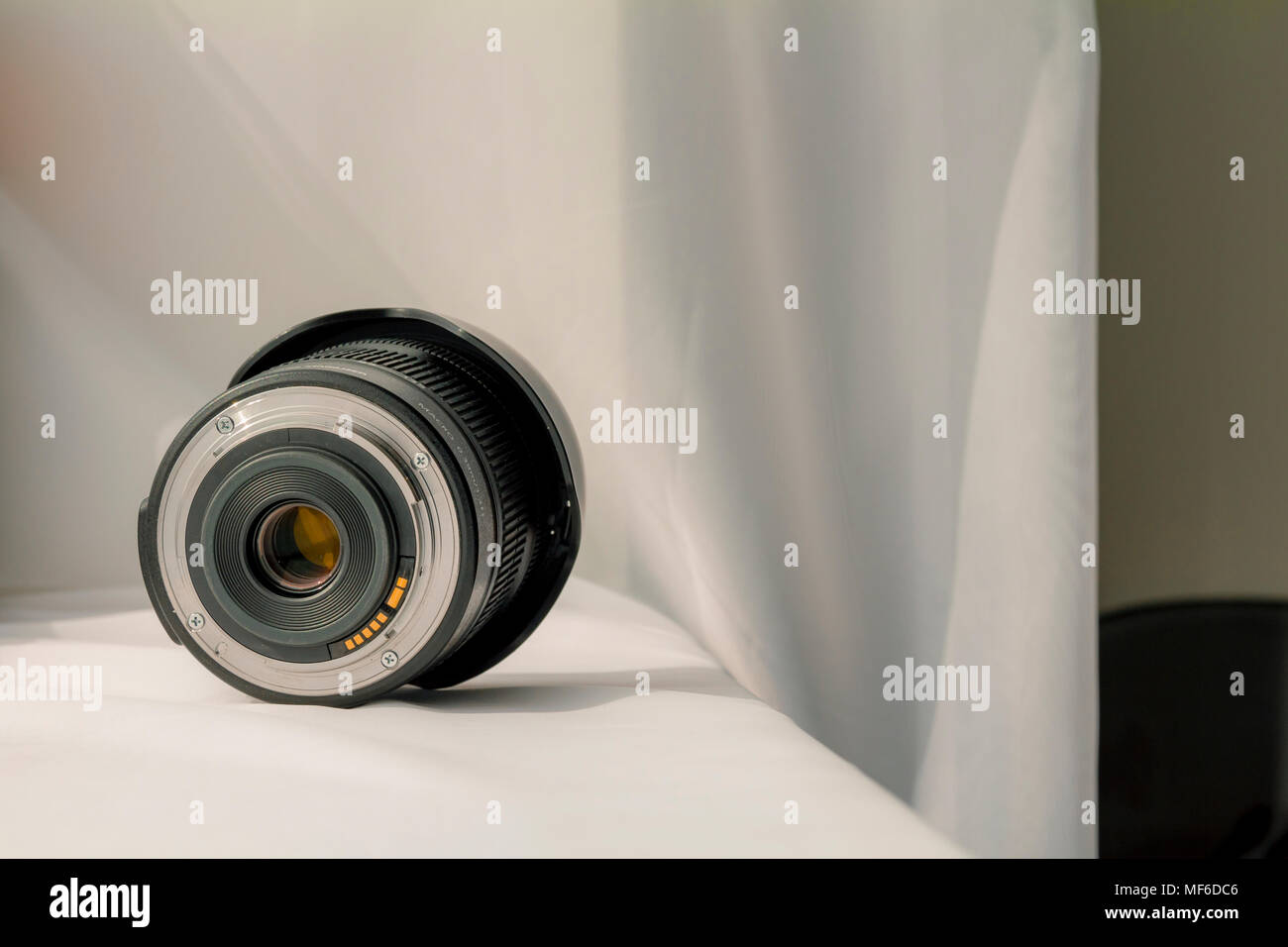 Black camera zoom lens on white cloth Stock Photo - Alamy