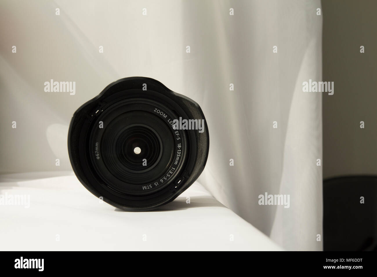 Black camera zoom lens on white cloth Stock Photo - Alamy