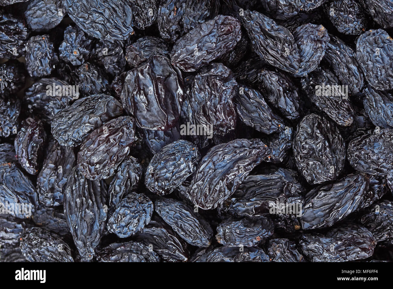 Black raisins background Stock Photo - Alamy