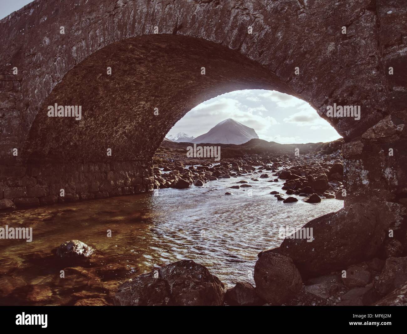 Stream and stony bridge in spring Hiigland mountains in Scotland. Snowy ...