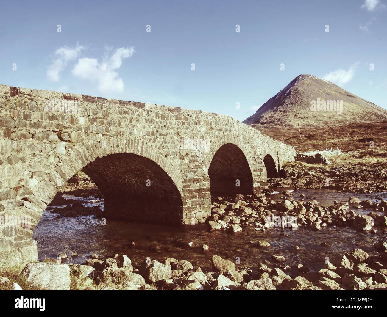 Stream and stony bridge in spring Hiigland mountains in Scotland. Snowy ...