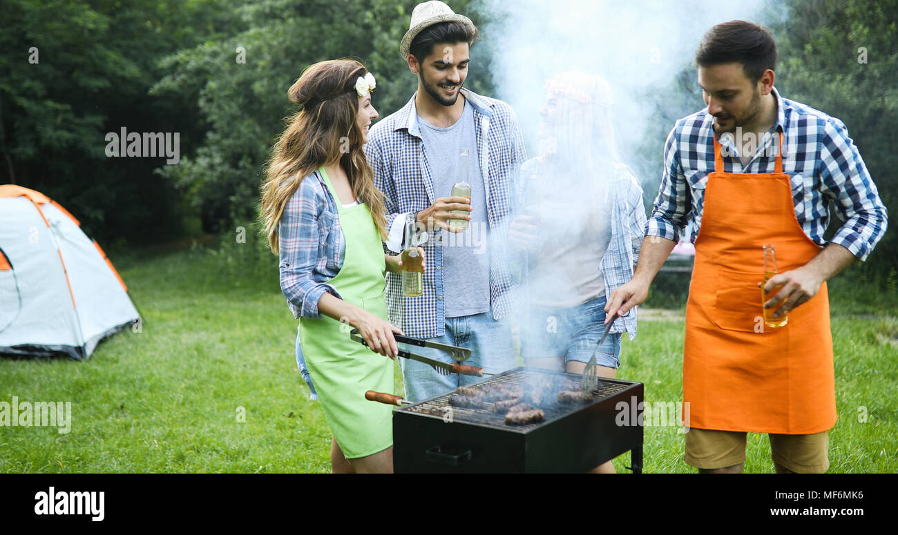 Happy friends enjoying barbecue party Stock Photo - Alamy