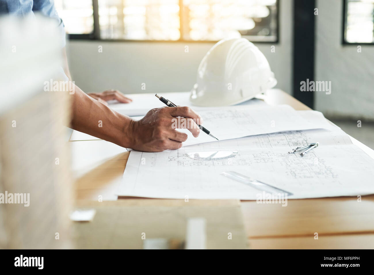Person's engineer Hand Drawing Plan On Blue Print with architect ...