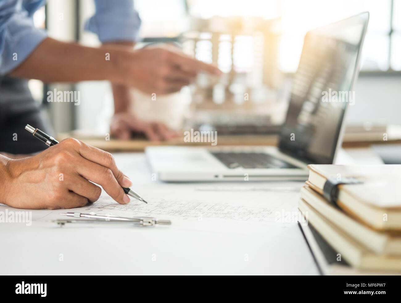 Close-up Of Person's engineer Hand Drawing Plan On Blue Print with ...
