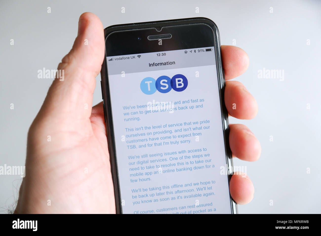 A customer using the TSB Online banking app on an iPhone reads a ...