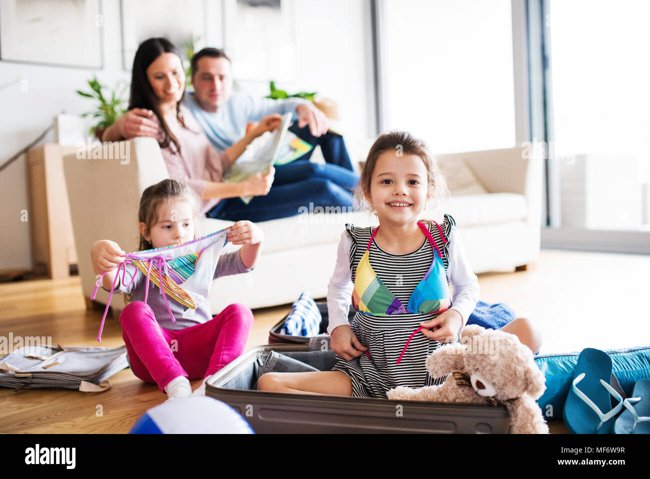 Young family with two children packing for holiday Stock Photo - Alamy