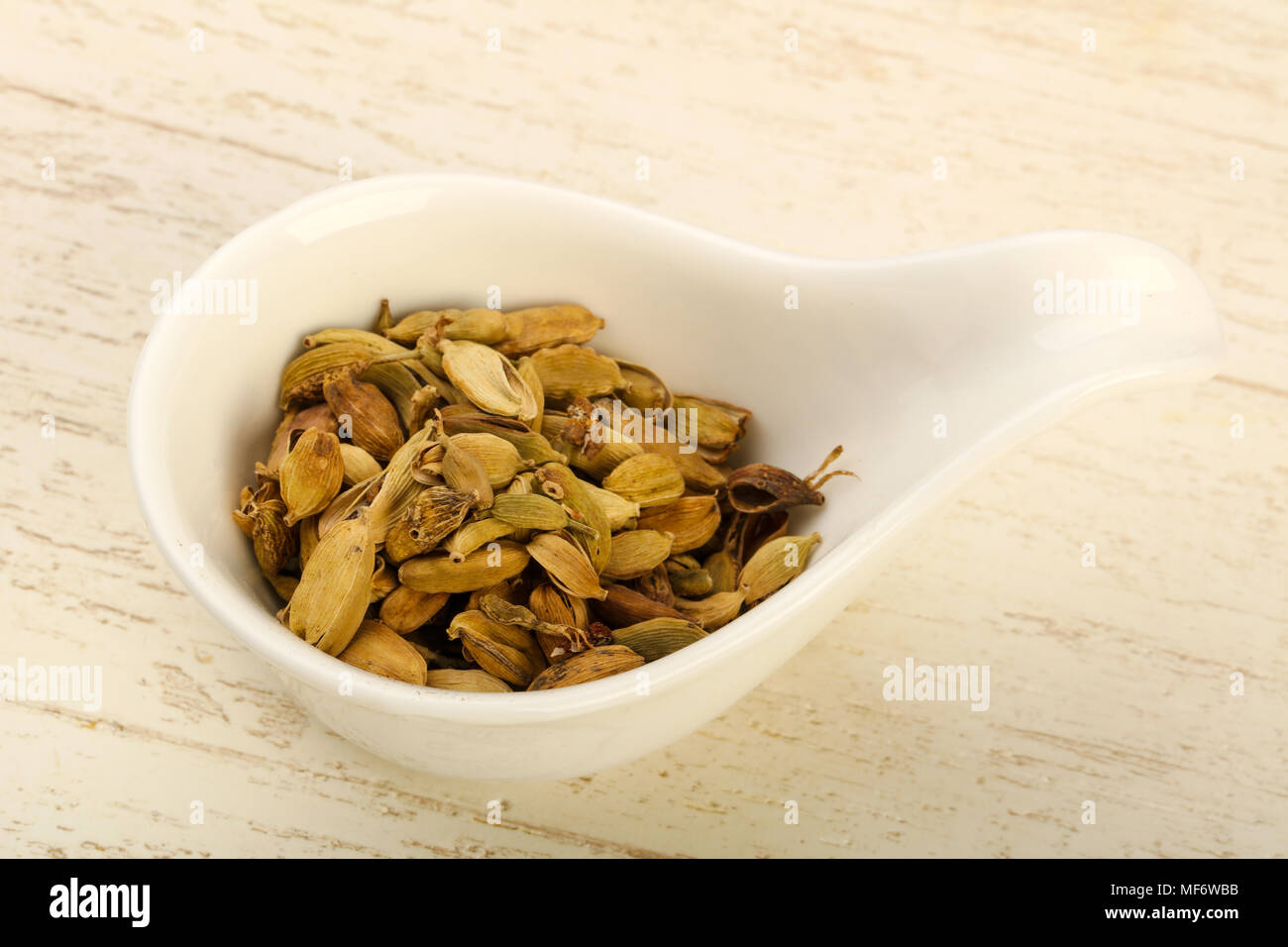Dry cardamom seeds heap in the bowl Stock Photo - Alamy