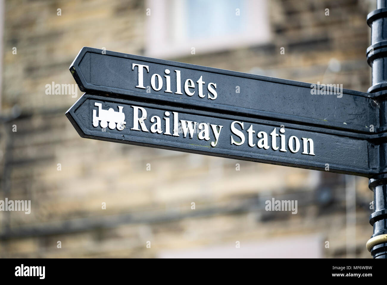Tourist information signpost on Main Street in the village of Haworth ...
