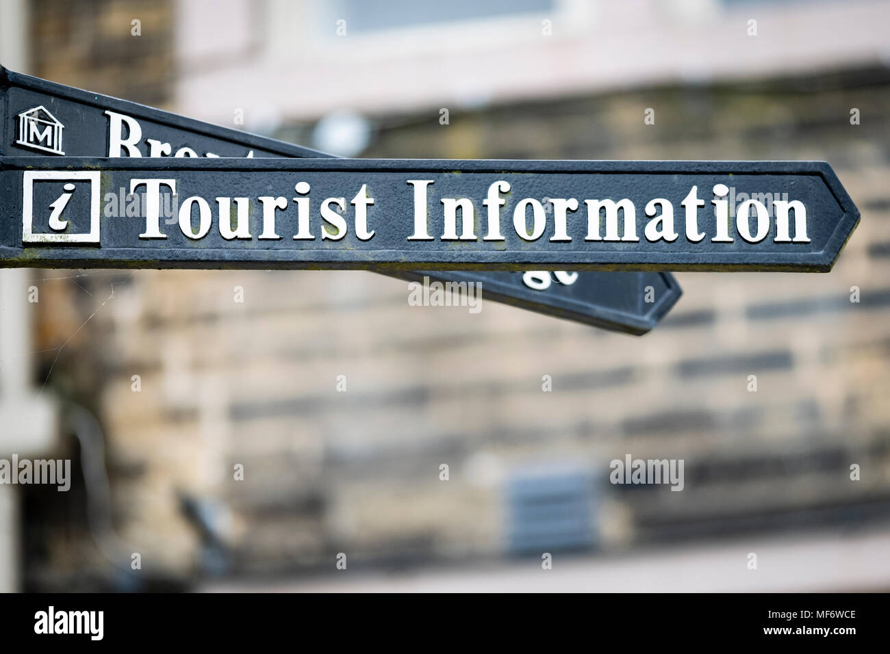 Tourist information signpost on Main Street in the village of Haworth ...