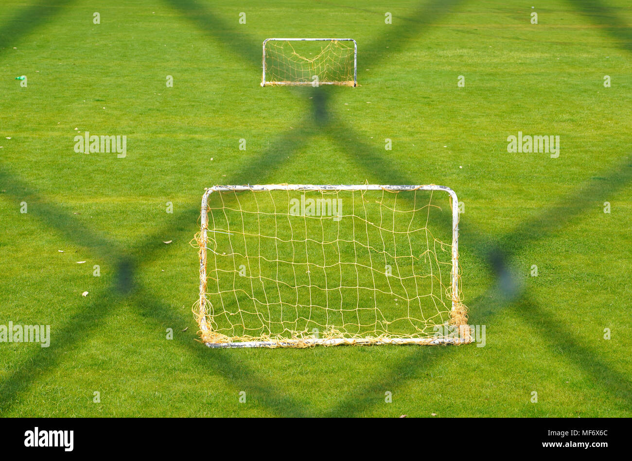 Small football field with two small goals outdoors on green grass ...