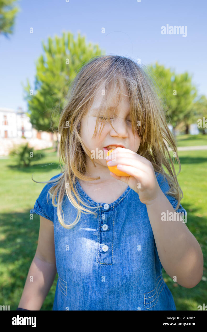 Boy biting peach hi-res stock photography and images - Alamy