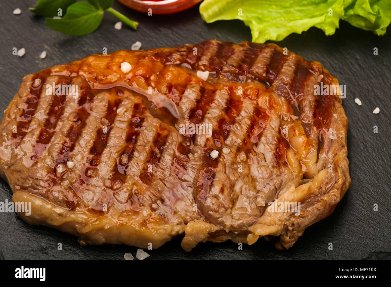 Grilled Rib eye steak with sauce Stock Photo - Alamy