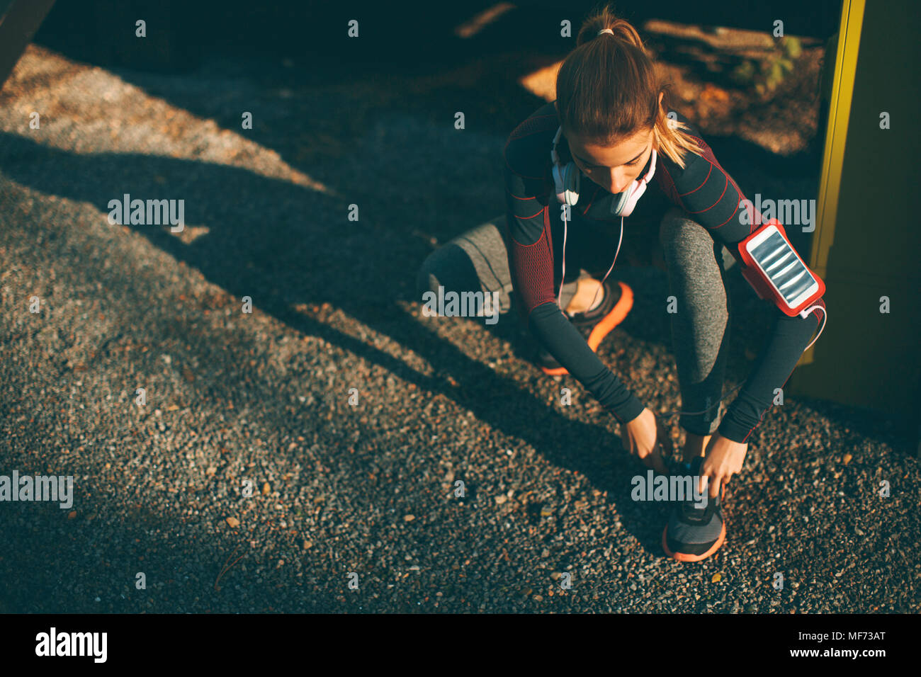 Attractive female runner taking break after jogging outdoors Stock ...