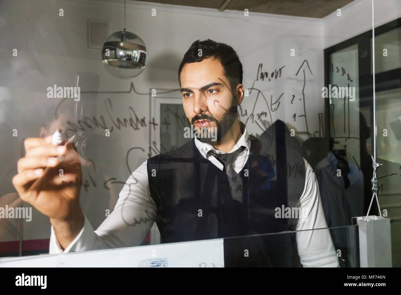 Making Notes on the Glass Wall Stock Photo - Alamy