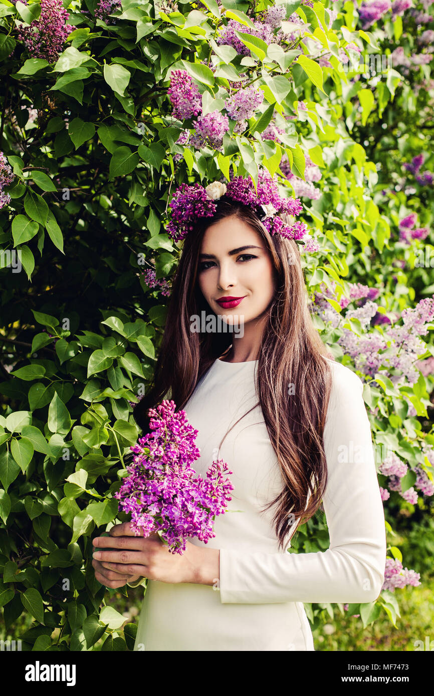 Perfect female model woman with spring lilac flowers outdoors. Long ...
