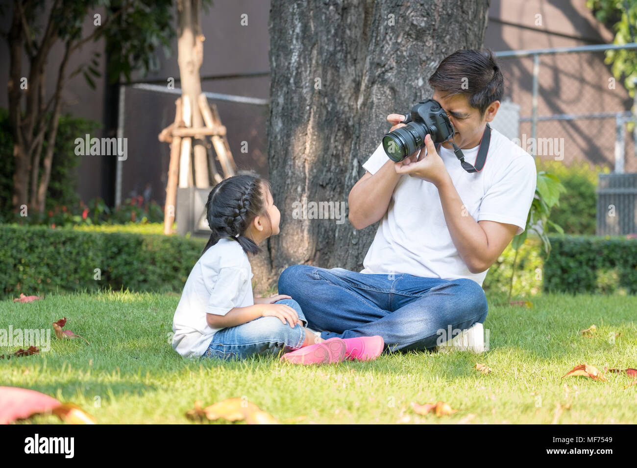 Father take photo with camera of daughter in house garden,family picnic ...